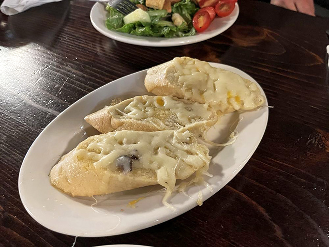 Garlic bread that's achieved the perfect cheese-to-bread ratio—the culinary equivalent of finding the sweet spot on your car radio.