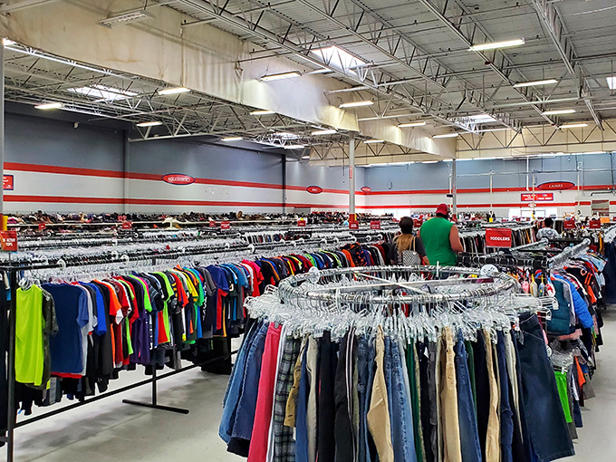 The clothing section stretches toward the horizon like a textile Grand Canyon. Color-coded racks create a rainbow road of fashion possibilities.