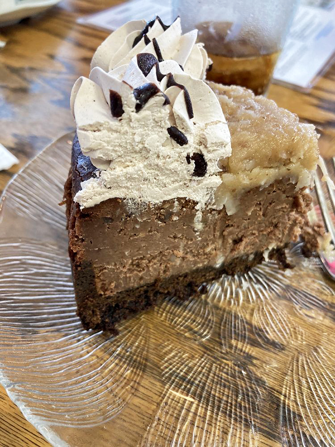 The German Chocolate Cheesecake performs the impossible magic trick of combining two perfect desserts into one mind-blowing experience.