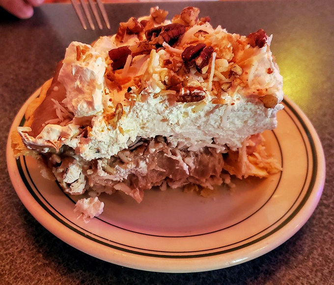 Not just dessert, but an engineering marvel. Layers of chocolate, coconut, and cream stacked higher than my childhood dreams of becoming an astronaut. 