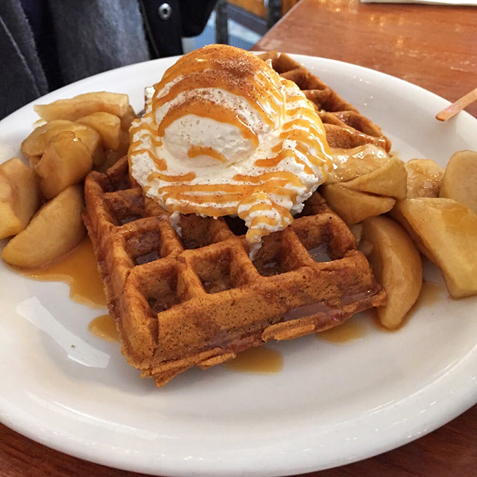 Breakfast nirvana achieved: a waffle that's both crisp and tender, topped with what can only be described as clouds of whipped cream.
