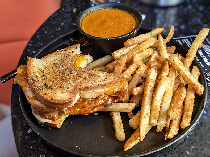 The legendary grilled cheese in its natural habitat&mdash;perfectly bronzed bread giving way to molten cheese, with a side cup of tomato soup for essential dunking operations.