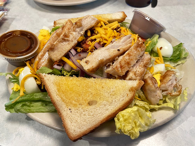 A salad that doesn't apologize for being delicious, with grilled chicken perched atop fresh greens like a protein-packed crown jewel of lunchtime satisfaction.