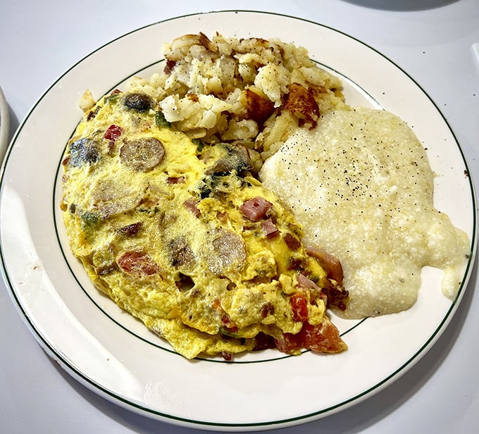 This omelette doesn't just contain ingredients—it showcases them. Those home fries have achieved the culinary holy grail: crispy exterior, fluffy interior.