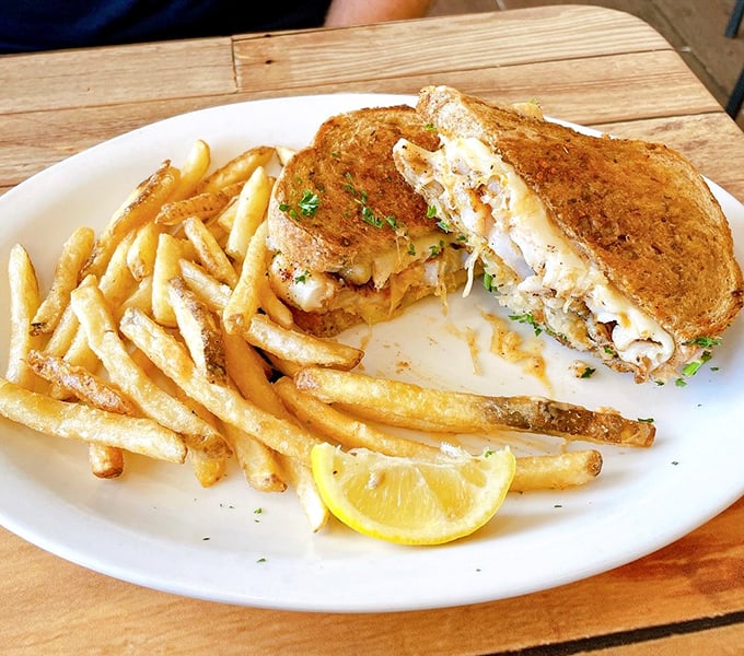 The legendary grouper sandwich &ndash; Florida's unofficial state food &ndash; served with crispy fries and a lemon wedge for that perfect citrus kick.