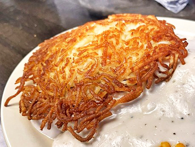 The humble hash brown, elevated to art form. Crispy, golden strands creating a nest of potato perfection that puts fancy brunch spots to shame.