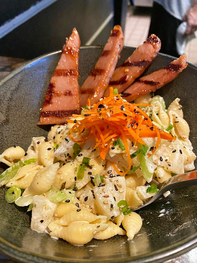 A Hawaiian-inspired mac and cheese that's having an identity crisis in the best possible way. Those glazed ham slices are the tropical vacation your pasta deserves.