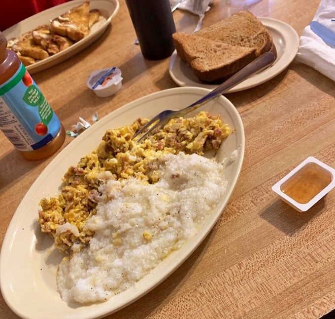 The breakfast plate that answers the eternal question: "Why would anyone eat cereal when this exists?" Eggs, grits, and meat in perfect harmony.