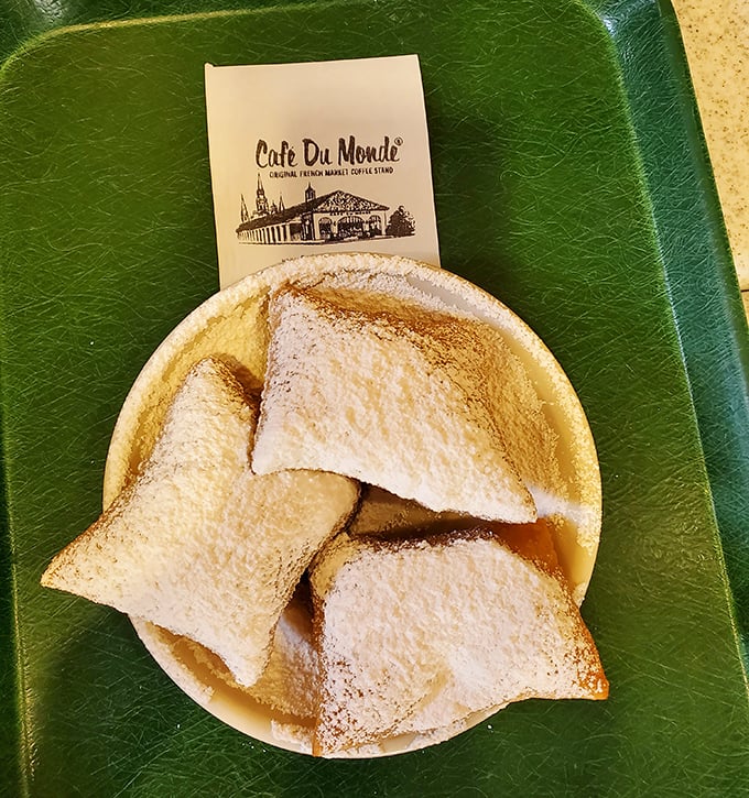 Three perfect squares on a simple plate. The beignet trinity delivers more joy per calorie than possibly any other food in existence.
