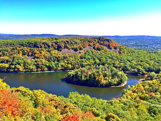 Hubbard Park's fall foliage creates a natural masterpiece around Mirror Lake, proving retirement eye candy doesn't require a premium cable package.