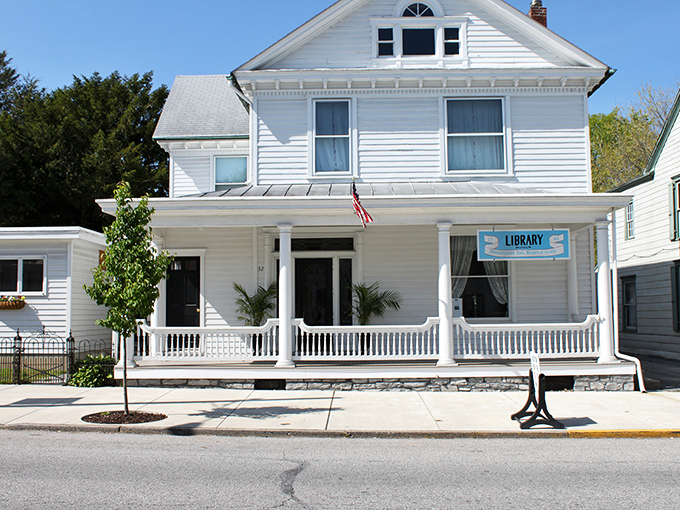 The town library's pristine white clapboard and welcoming porch swing the perfect balance between Norman Rockwell nostalgia and modern community service.