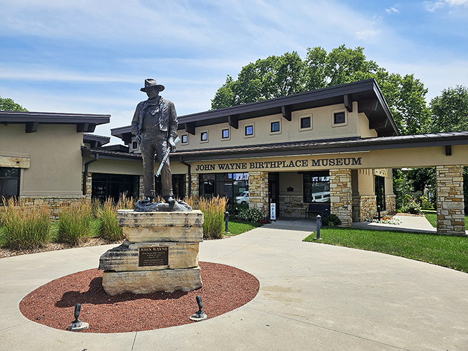 The Duke stands guard outside his birthplace museum, a reminder that even Hollywood legends come from somewhere small and real.