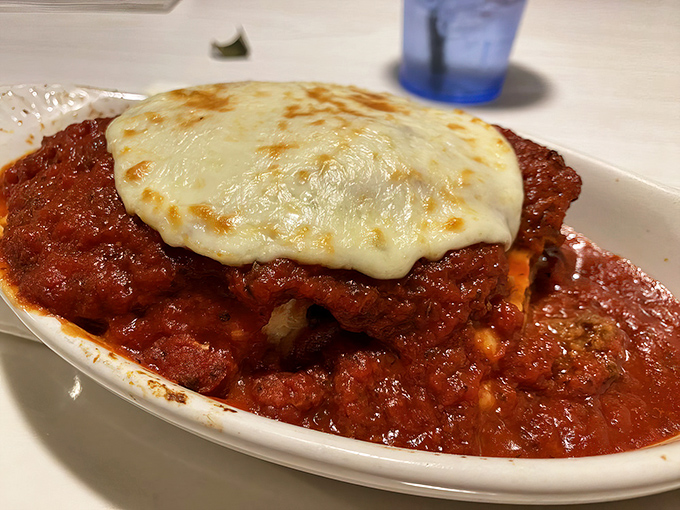 Behold the chicken parmesan in all its glory—a masterpiece where cheese meets chicken in a pool of ruby-red sauce that would make any nonna proud.