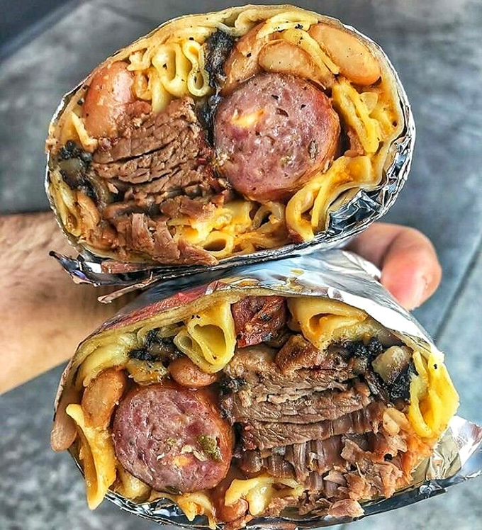 This burrito cross-section reveals the architectural genius behind La Banqueta's creations. Multiple meats, beans, and noodles coexisting in perfect harmony &ndash; if only world peace were this achievable.