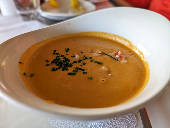 This lobster bisque isn't just soup; it's a warm hug in a bowl, with chunks of lobster playing hide and seek beneath that velvety surface. 