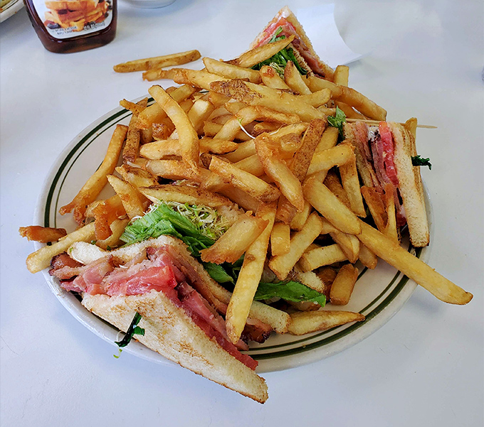 The club sandwich&mdash;mankind's greatest architectural achievement involving bread&mdash;flanked by an army of those legendary hand-cut fries.