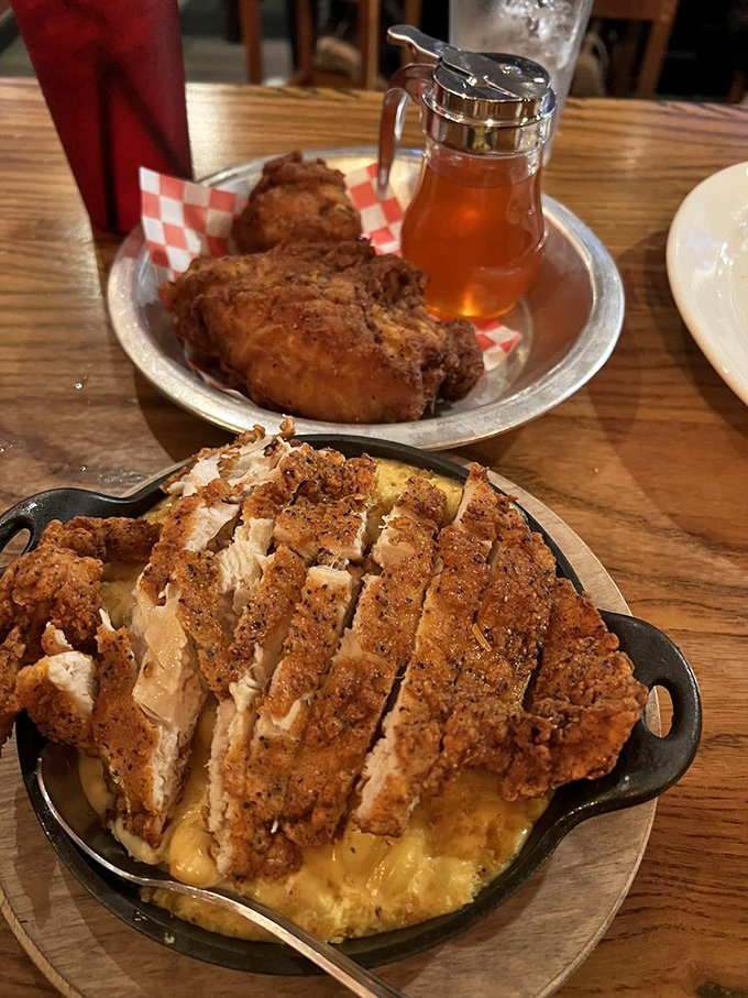 Comfort food nirvana: Crispy fried chicken atop creamy mac and cheese creates a textural symphony that makes your taste buds stand up and applaud.