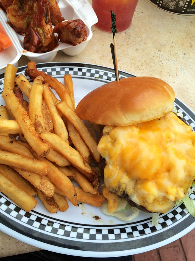 Behold the cheese-draped burger of your dreams, served with golden fries on their signature checkered plate. Diet plans, consider yourselves postponed.