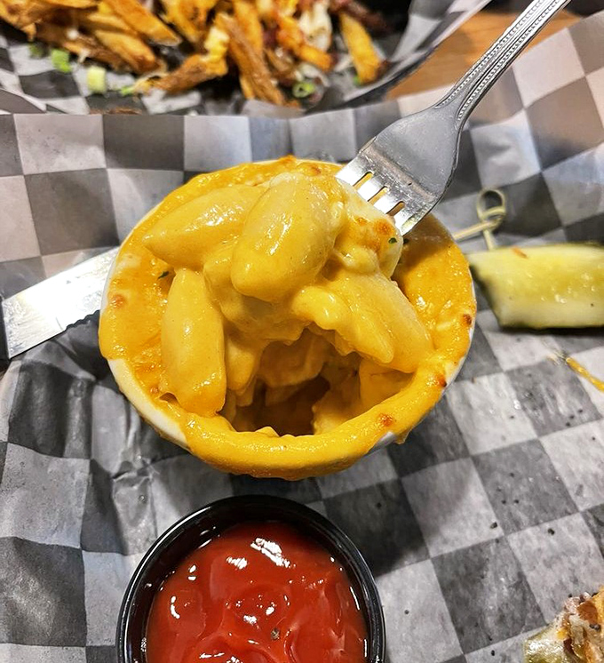 The fork-lift moment we all live for&mdash;when perfectly cooked pasta meets molten cheese sauce. A symphony of comfort in every bite.