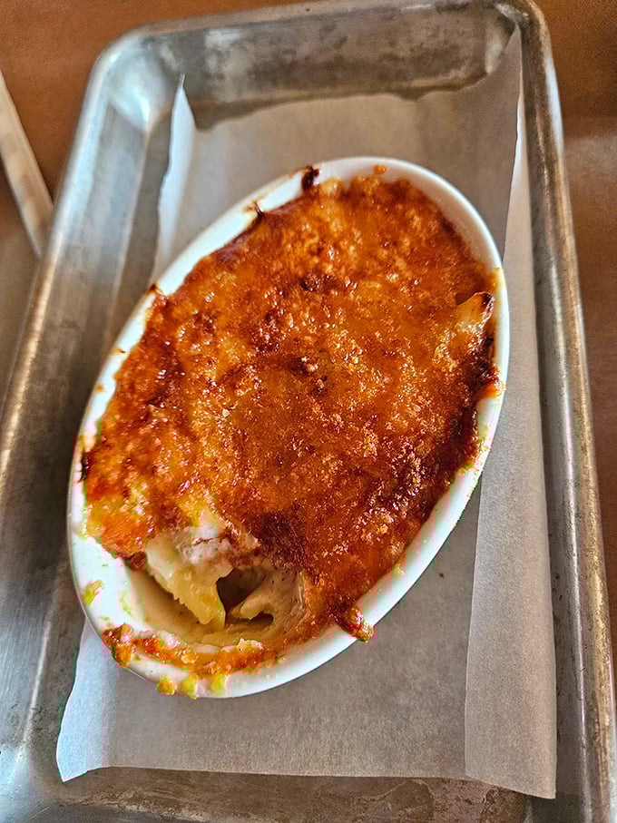 This isn't just mac and cheese; it's a religious experience in an oval dish. The burnished top gives way to creamy pasta beneath &ndash; worth every minute of the wait.