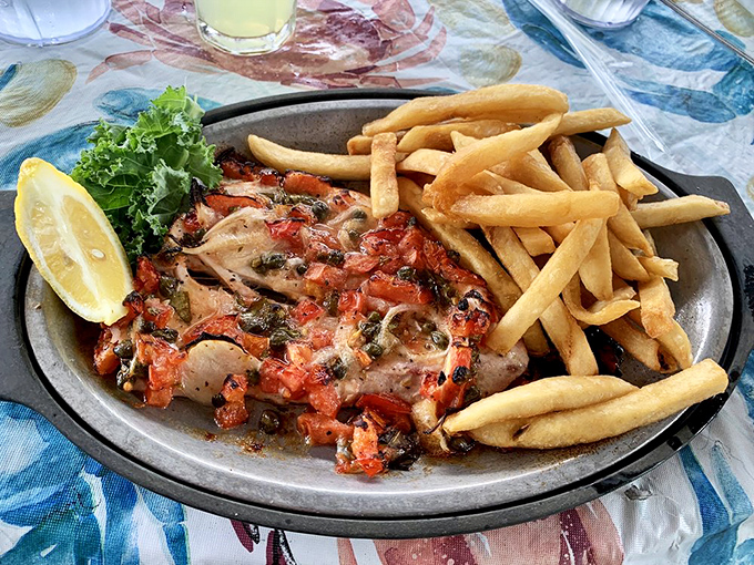 Matecumbe-style fish that's dressed better than most people at a Keys wedding. Those tomatoes and capers are having a party.