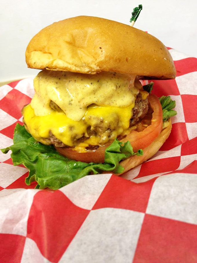 Cheese cascading down like a yellow waterfall of joy. This isn't just a burger&mdash;it's edible architecture with purpose.