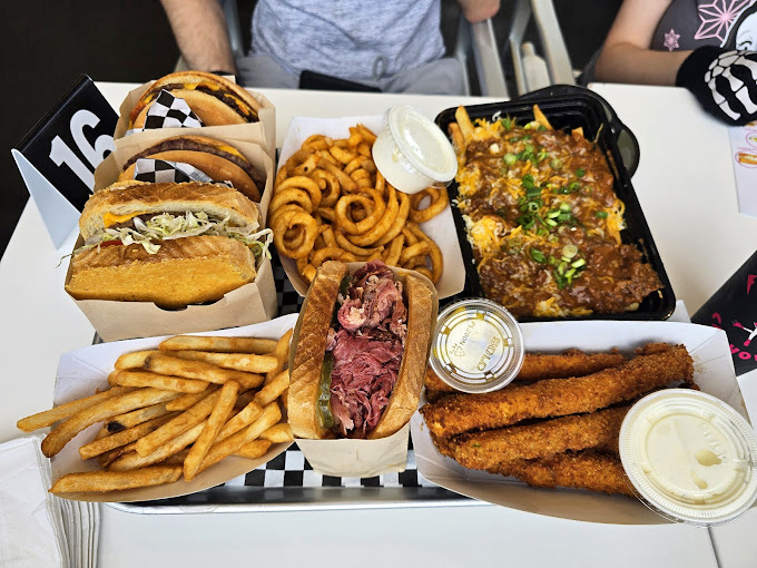 Food that arrives like a beautiful, delicious army. The curly fries alone would be worth the drive, but that pastrami sandwich? That's the stuff of lunch break daydreams.