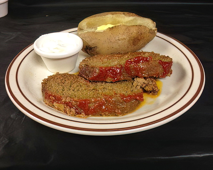 Meatloaf that would make your grandmother both proud and jealous. The sauce glistens with promise, while the baked potato stands by, ready for its supporting role.