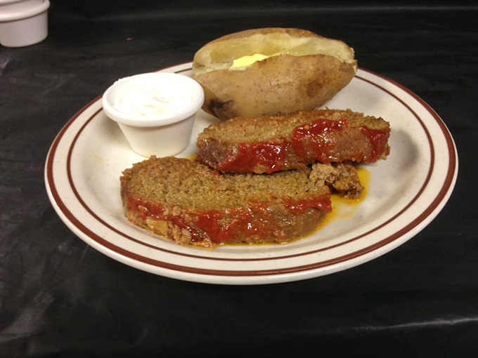 Meatloaf that doesn't apologize for being meatloaf. Served with a baked potato and sauce that glistens with promise, this is American comfort defined.