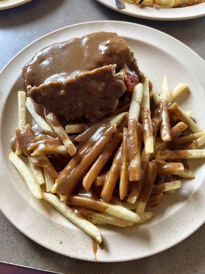 Gravy isn't a condiment here&mdash;it's practically a beverage, generously blanketing this meatloaf sandwich and transforming ordinary fries into vehicles for deliciousness.