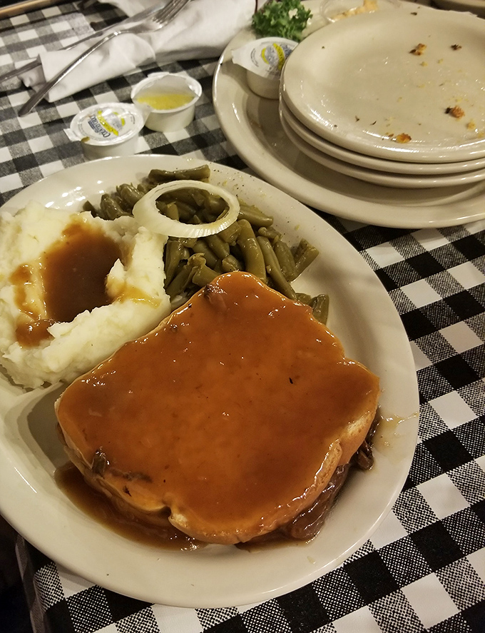 Meatloaf that doesn't just sit on the plate &ndash; it commands respect. Paired with those mashed potatoes and green beans, it's Kentucky's answer to a hug.