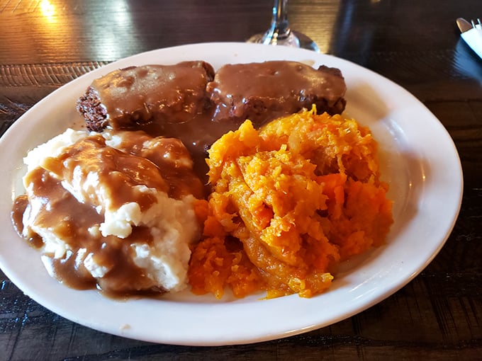 This is what comfort looks like on a plate&mdash;meatloaf bathed in rich gravy, alongside creamy mashed potatoes and vibrant sweet potato mash.