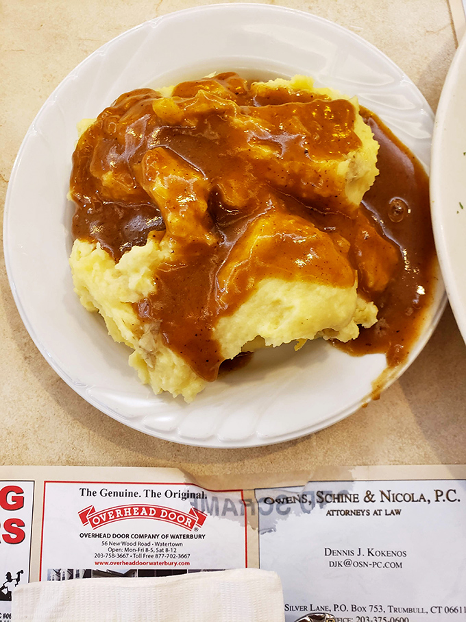 Those mashed potatoes aren't just a side dish &ndash; they're a golden lake of buttery goodness waiting for that river of homemade gravy. Pure comfort on a plate.