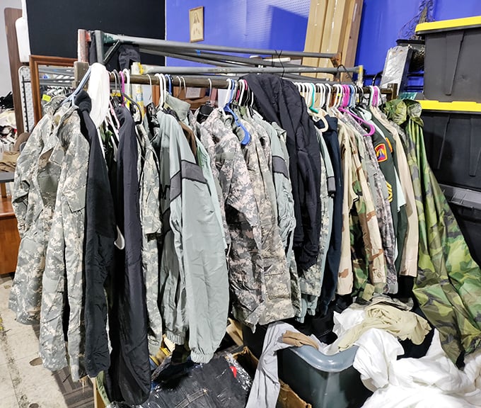 Military and outdoor gear hangs in formation, each jacket with stories stitched into its seams, waiting for new adventures.