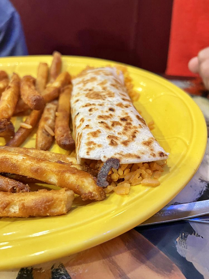 The perfect marriage of cultures: a golden-grilled burrito nestled against crispy fries—proof that some relationships are meant to be.