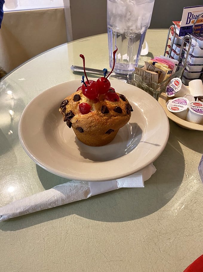 This chocolate chip muffin topped with cherries isn't just breakfast&mdash;it's dessert with an alibi, standing proud as morning's guilty pleasure.