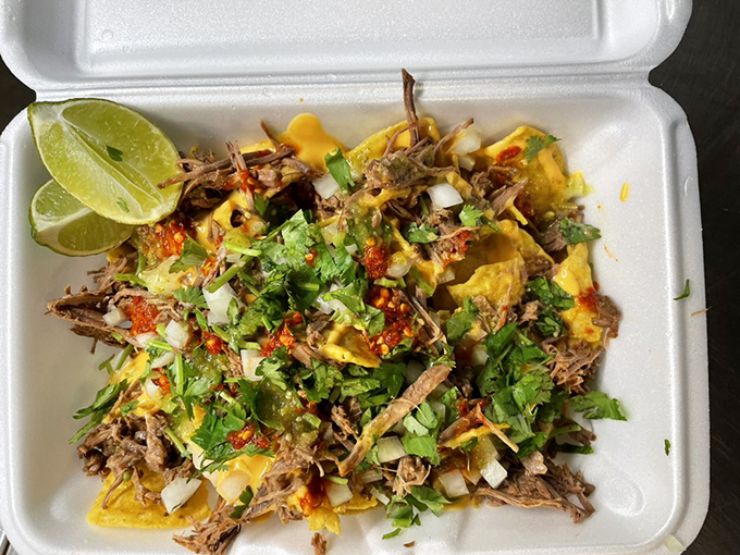 Even in a to-go container, these nachos maintain their dignity. The cilantro-to-meat ratio here would make any abuela proud.
