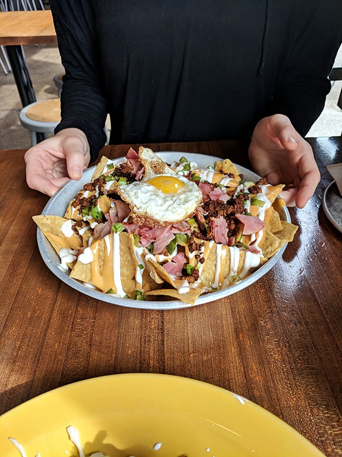 Breakfast meets happy hour with this nacho masterpiece topped with a sunny-side-up egg &ndash; the hangover cure you never knew you needed.