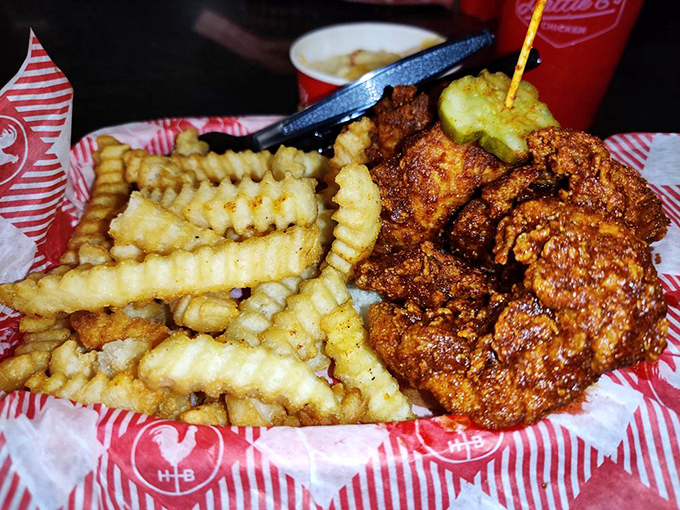 The vibrant red coating isn't just for show—it's a warning. Those crinkle-cut fries provide necessary relief between bites of fiery goodness.