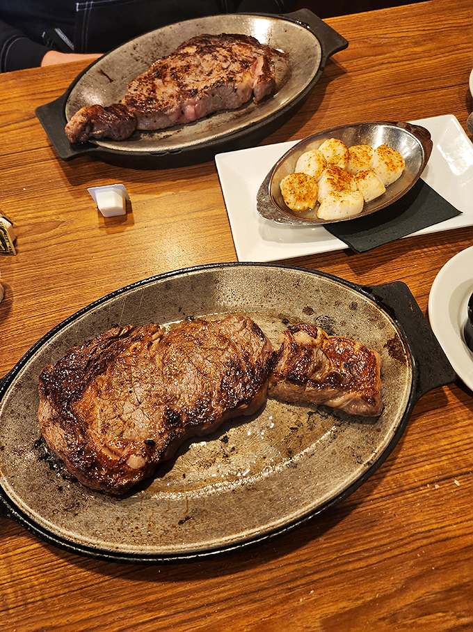 Steak perfection doesn't need fancy frills. This New York Strip with golden scallops on the side speaks the universal language of "get in my belly."