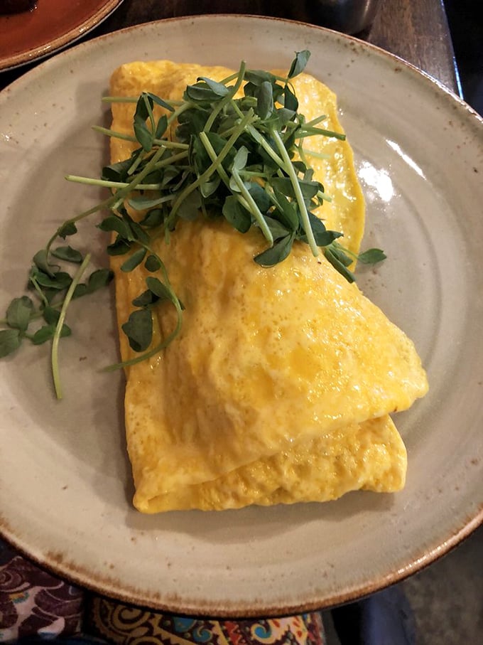 An omelet so perfectly executed it deserves its own cooking show. The pea shoots aren't just garnish&mdash;they're the supporting actors that steal the scene.