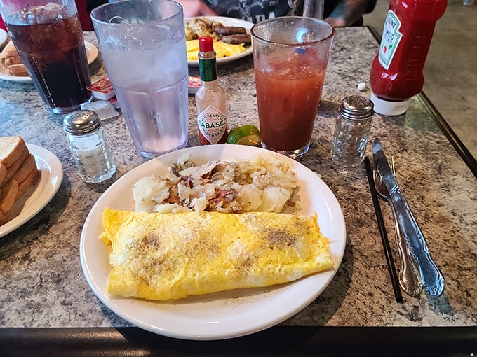 Breakfast doesn't get more honest than this—a perfectly executed omelet with potatoes that could make a hash brown weep with jealousy.