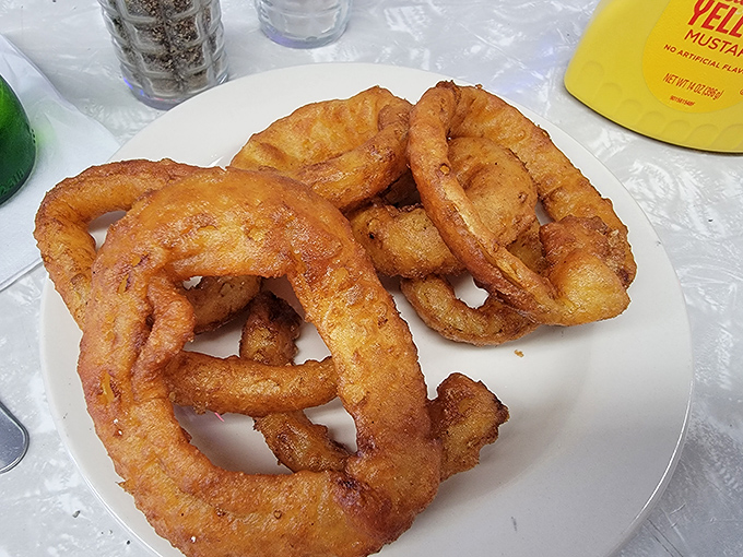 These golden onion rings aren't just a side dish; they're crispy halos of happiness that deserve their own moment of silence.