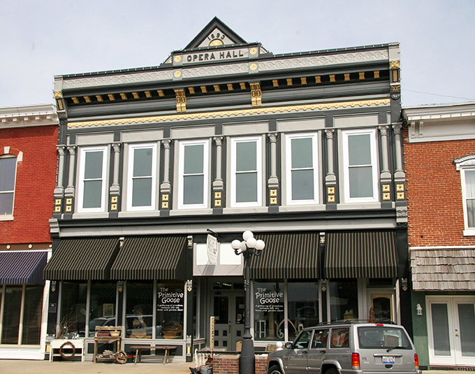 The Opera Hall fa&ccedil;ade proves that even small towns once prioritized cultural experiences alongside their hardware stores.