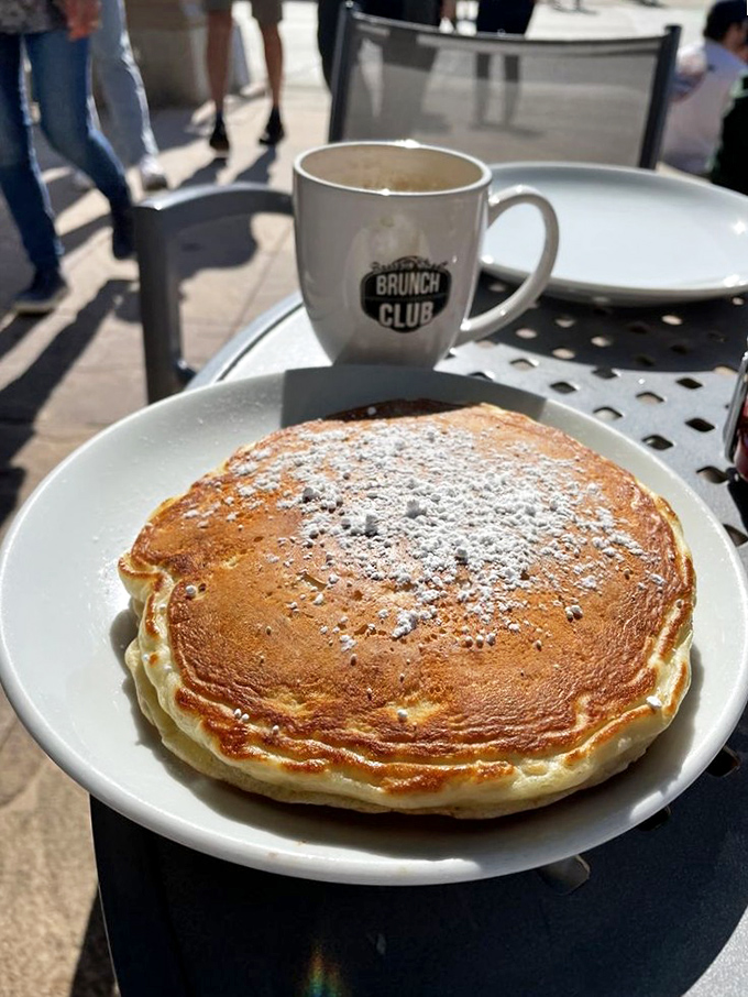 This isn't just a pancake&mdash;it's a fluffy disc of joy dusted with powdered sugar, demanding to be photographed before it's devoured.