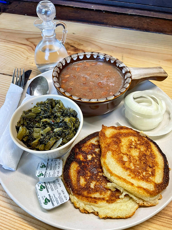 Cornbread that shatters perfectly, turnip greens swimming in pot likker, and a bowl of pinto beans that could convert any vegetable skeptic.