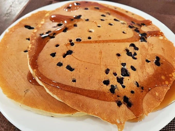 Golden-brown perfection with chocolate chips scattered like treasures in a fluffy landscape. Breakfast archaeology never tasted so good.
