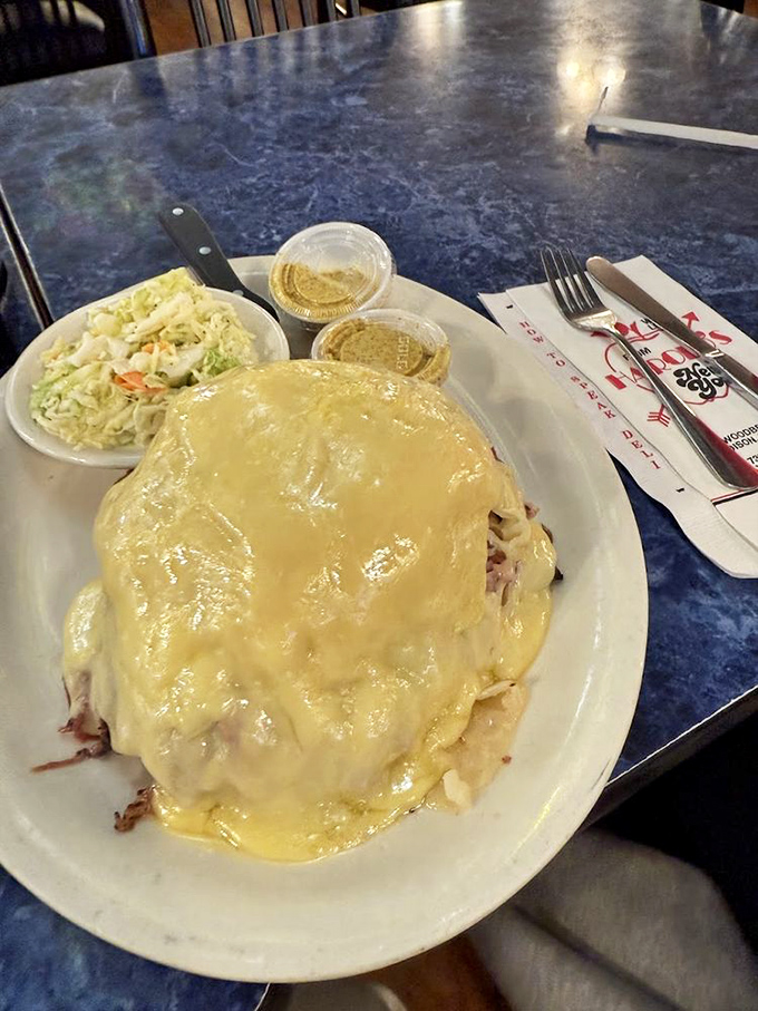 What looks like a mountain of melted cheese is actually Harold's Pastrami Reuben. Archaeologists could study the delicious layers of this sandwich for years.