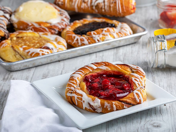 Danish pastries that would make your cardiologist wince and your inner child applaud. That cherry-filled beauty is practically winking at you. 