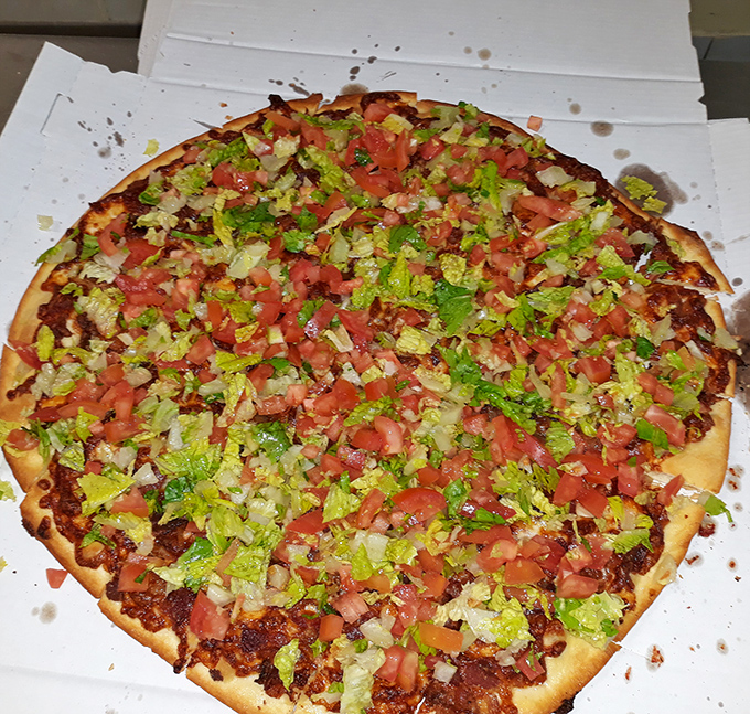 This taco-inspired pizza masterpiece proves Nardi's isn't afraid to venture beyond tradition. Fresh lettuce and tomato create a garden atop that glorious crust.